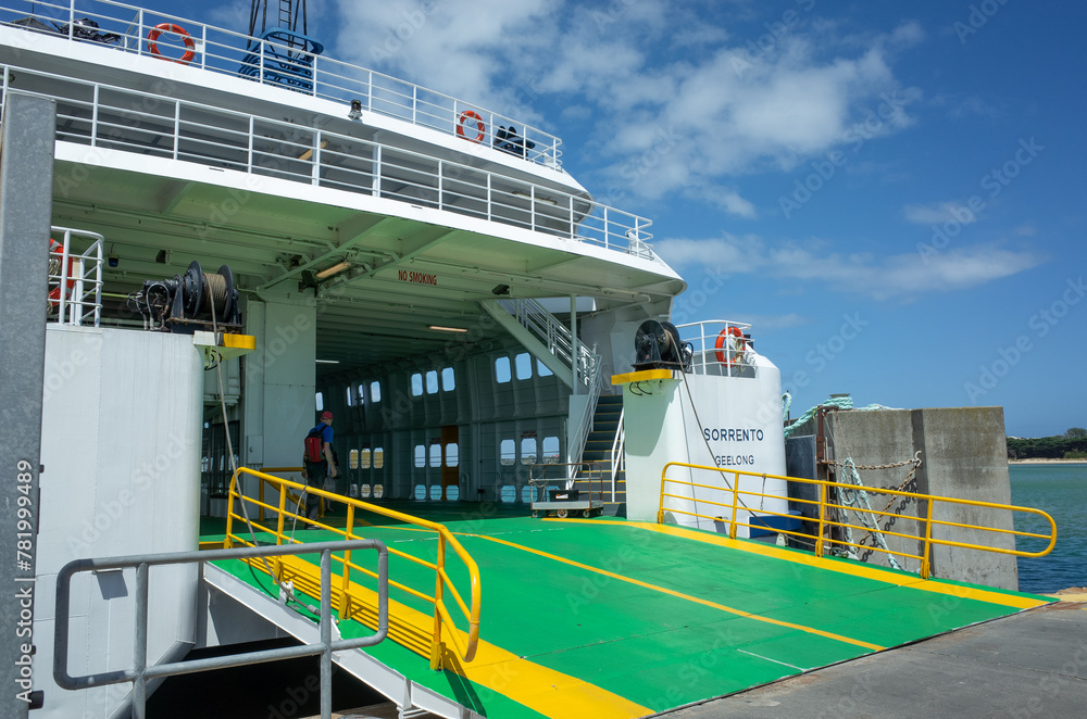 a Searoad ferry docked at a pier, with its deck or door lowered to ...