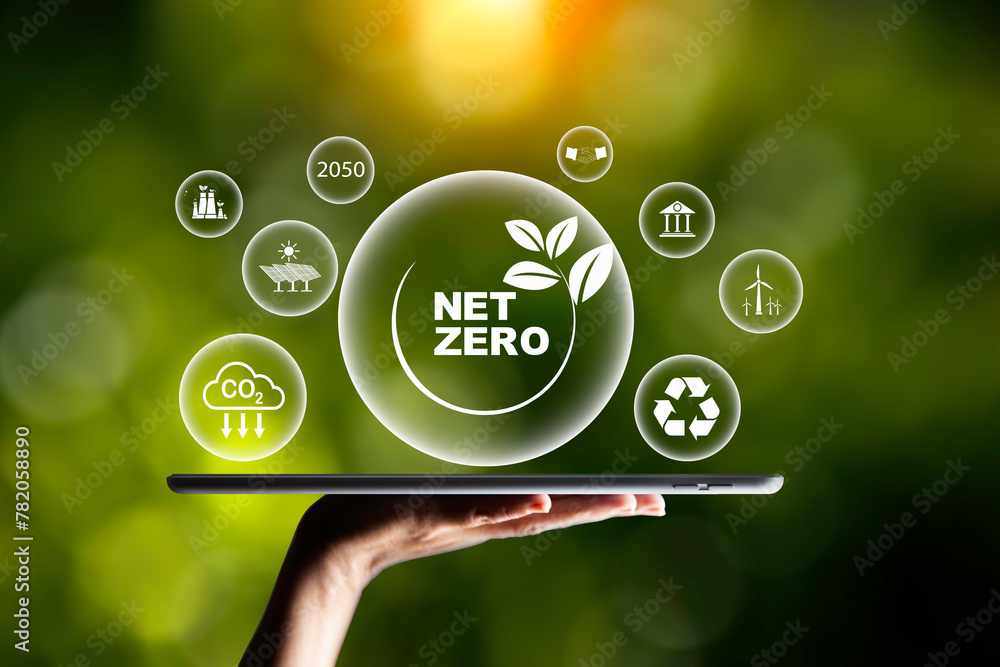 Net zero, carbon neutrality concept. Net zero and Green energy icon around it at on laptop ...