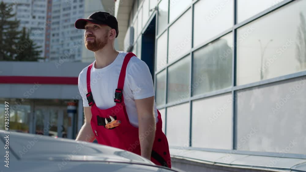 At automotive service center mechanic skillfully attends to car with ...