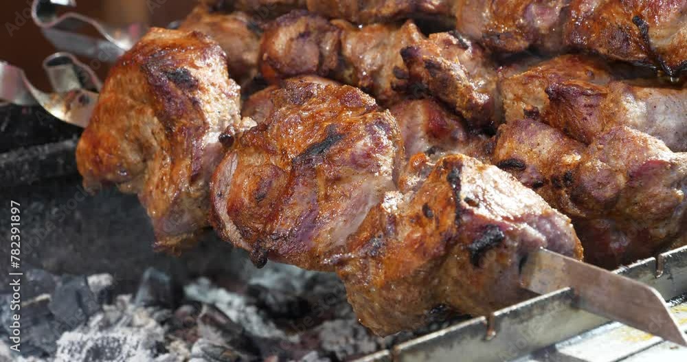 Big fat shish kebab broils in barbecue. Meat are cooked on hot coals in ...