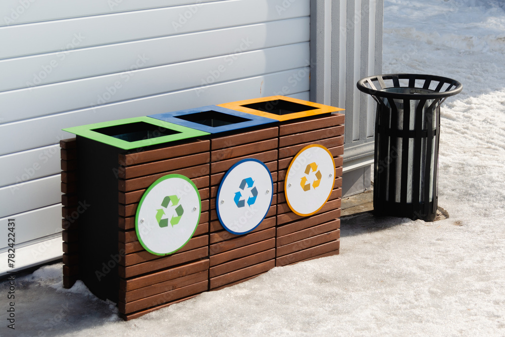 Recycling bins on city street. Collection of waste bins full of ...