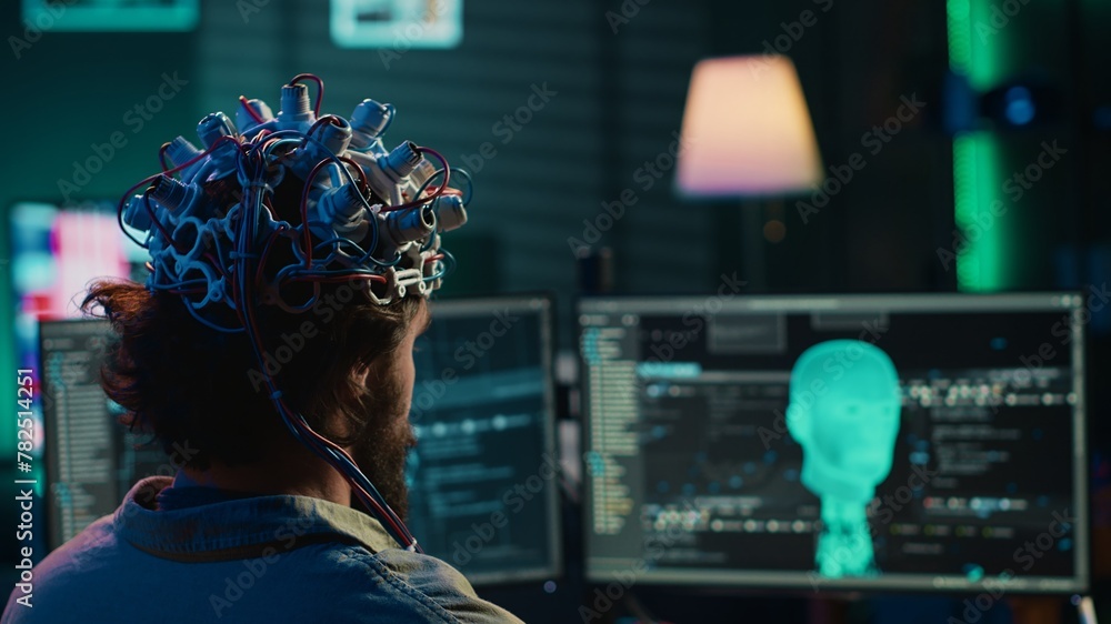 Developer with EEG headset on programming brain transfer into computer ...