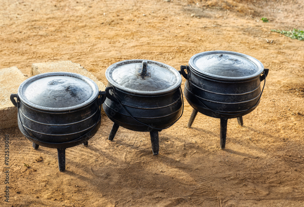africa three cooking pots outside in the yard cooking meat the ...