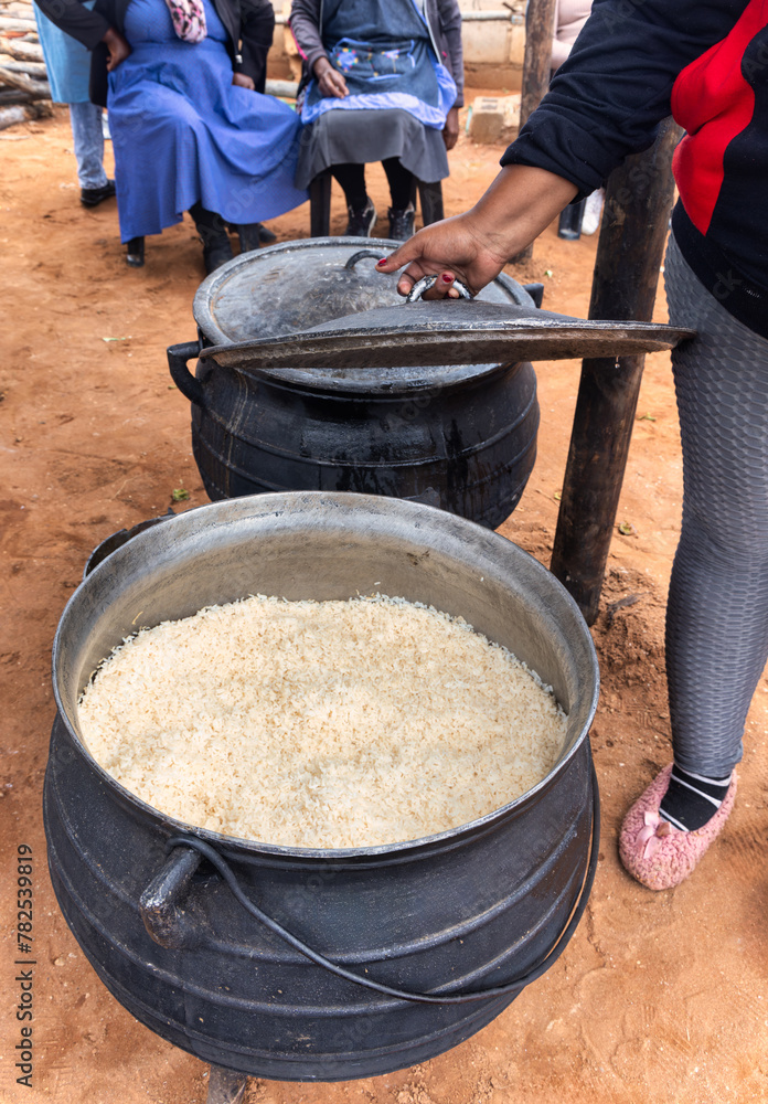 pot of rice boiling in an three legged pot, outdoors kitchen african ...