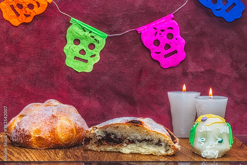 Bread of the dead filled with chocolate, decorated with candles, sugar ...