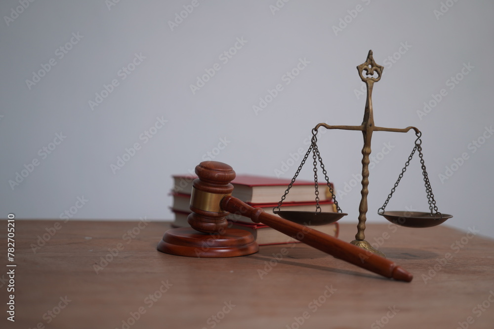 A judge's gavel, a symbol of authority, rests on a grey background. Its ...
