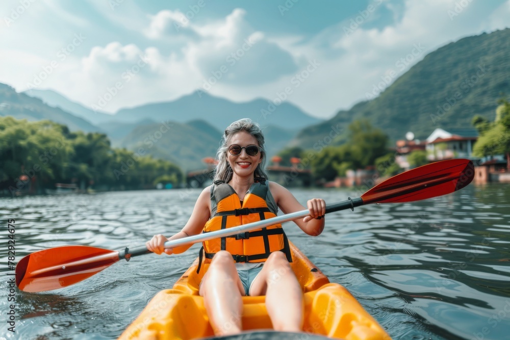 Elegant Lady Kayaking in a Serene Lake with Beautiful Landscape ...