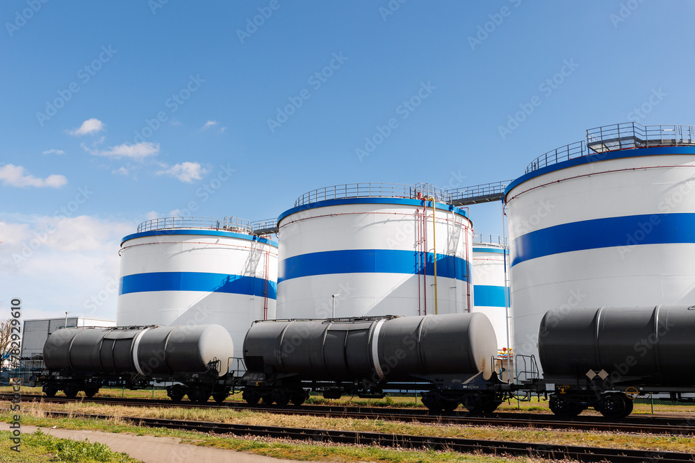Row many large industrial fuel storage white tanks clear blue sky ...
