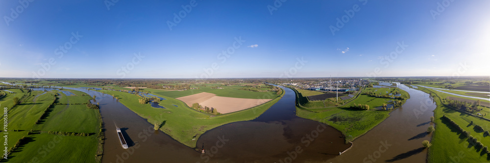 Dutch landscape panorama of wind turbine and solar panels with waterway ...
