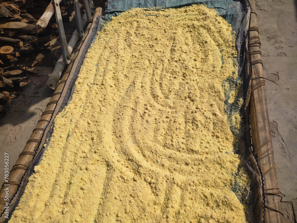 Jaggery Powder drying in the hot sun. Golden or yellow color sweet ...