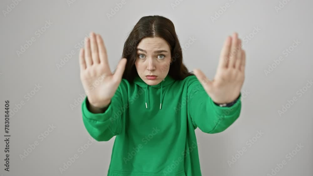 Frustrated young woman, sweater clad and standing on a white isolated ...