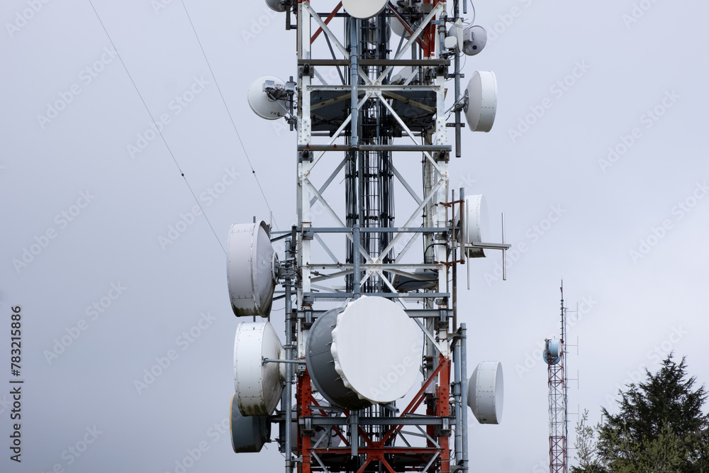 The tower stands tall with numerous antennas attached to it, serving as ...