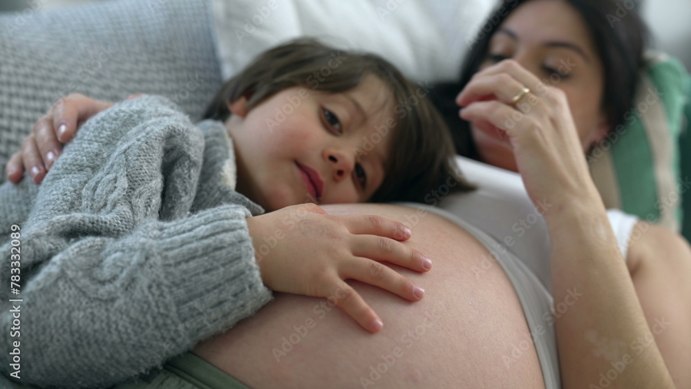 Son leaning on mother's belly during third trimester pregnancy. Tender ...