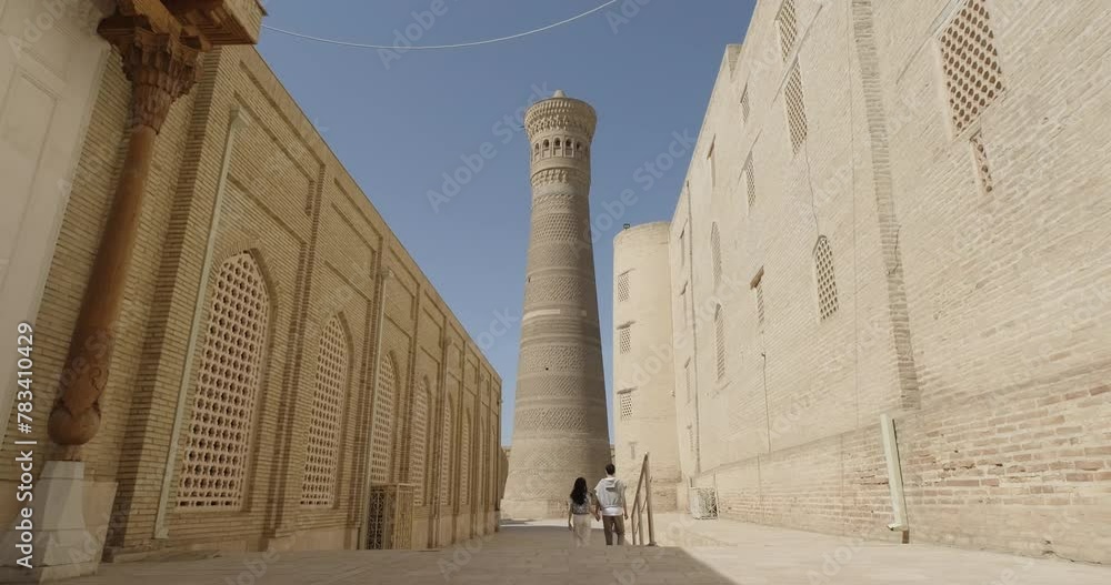 Young couple walking together to Kalan minaret, Po-i-Kalyan complex in ...