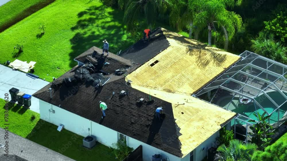 Construction workers changing house roof covering. Repair of Florida ...