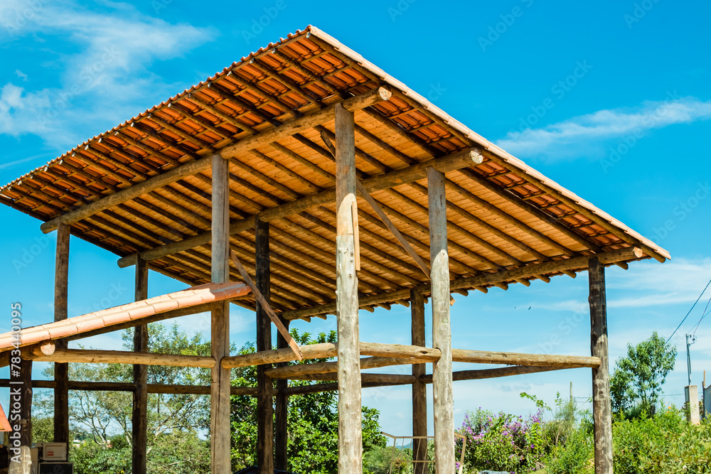 Work on the construction of a wooden building with round eucalyptus ...