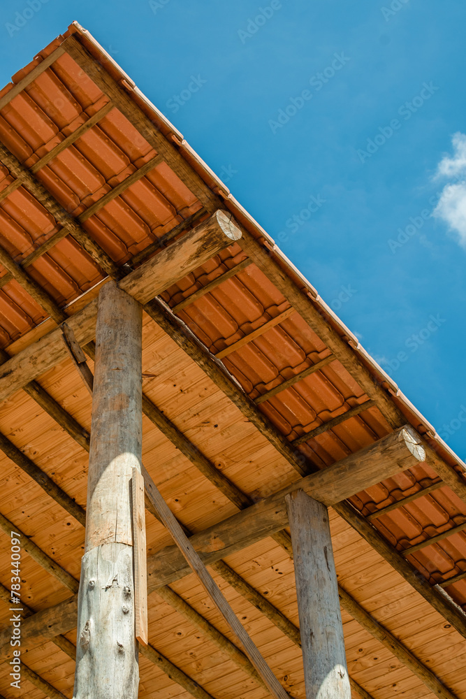 Work on the construction of a wooden building with round eucalyptus ...