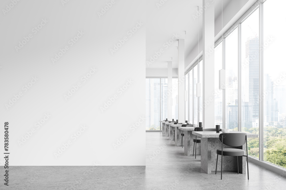 White restaurant interior with seats and tables in row near window ...