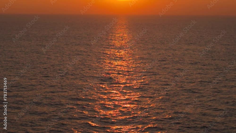 Reflection of golden light of rising sun in ocean water at Lakshadweep ...