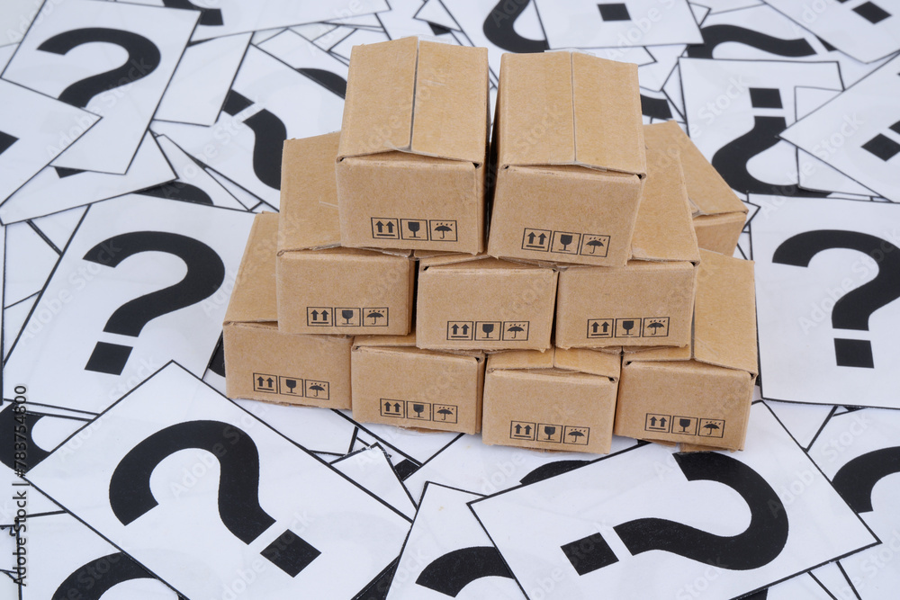 Goods and delivery FAQ concept. Many shipping carton boxes on question ...