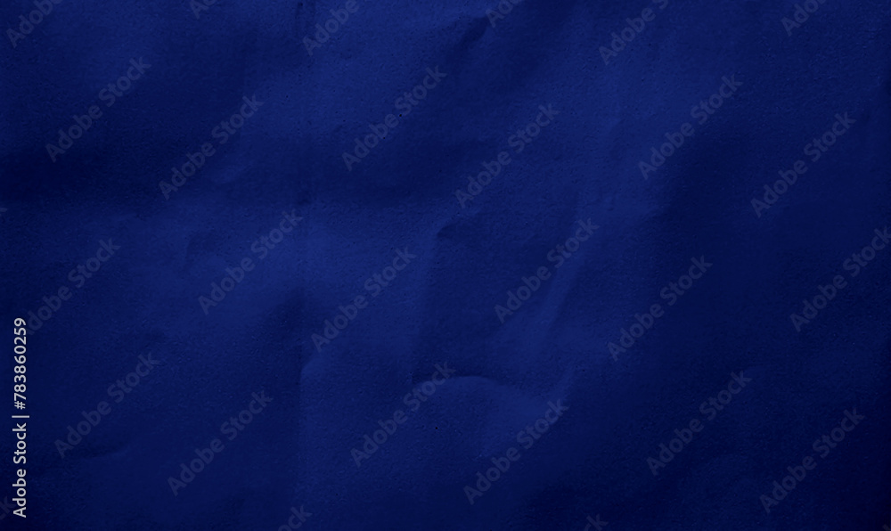 close up crumpled dark blue kraft paper background showing crease ...