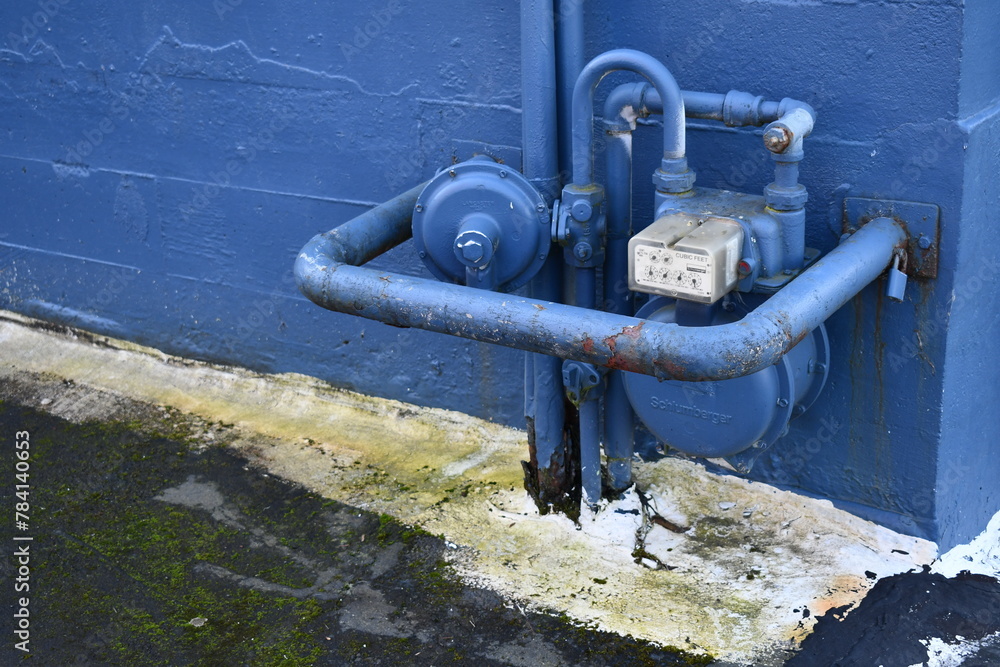 Schlumberger gas meter protected by metal pipe. Painted blue to match ...