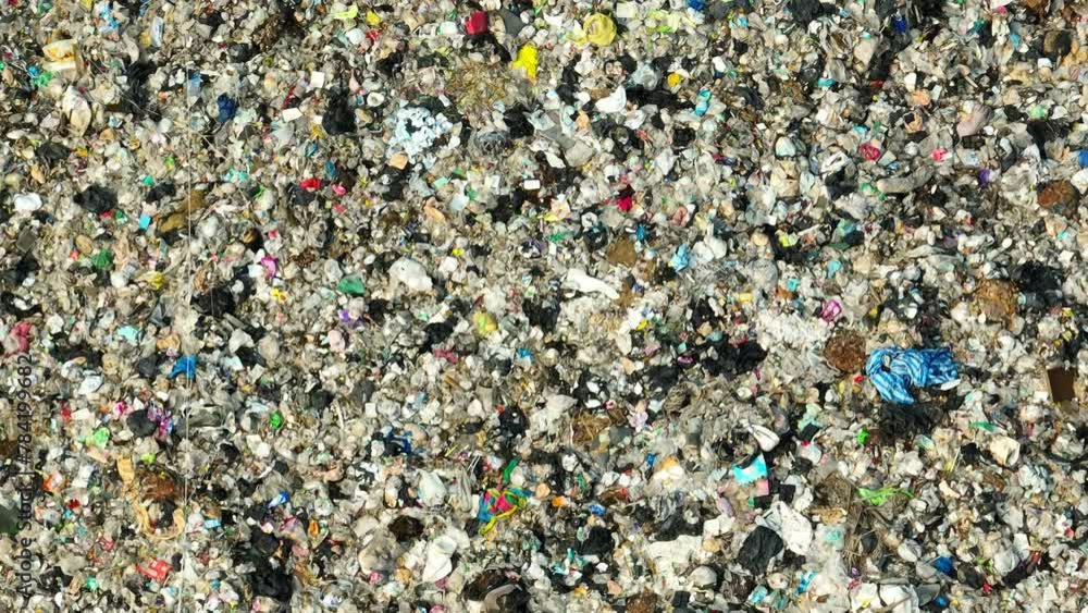 A densely packed waste field with scattered items of varying colors ...
