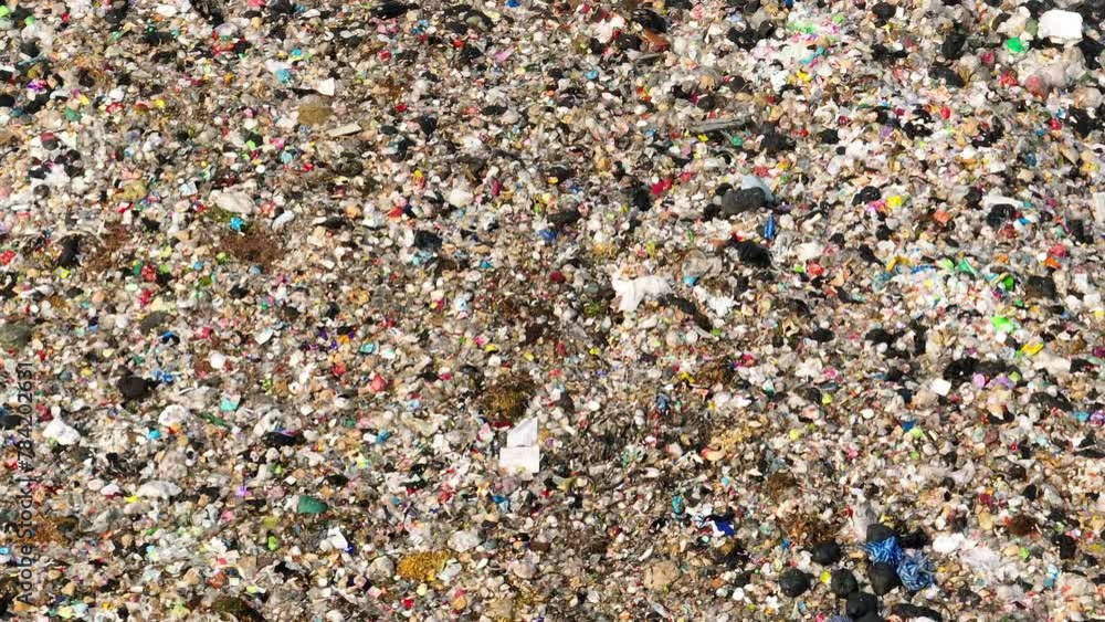 A tightly packed expanse of trash, depicting a variety of discarded ...