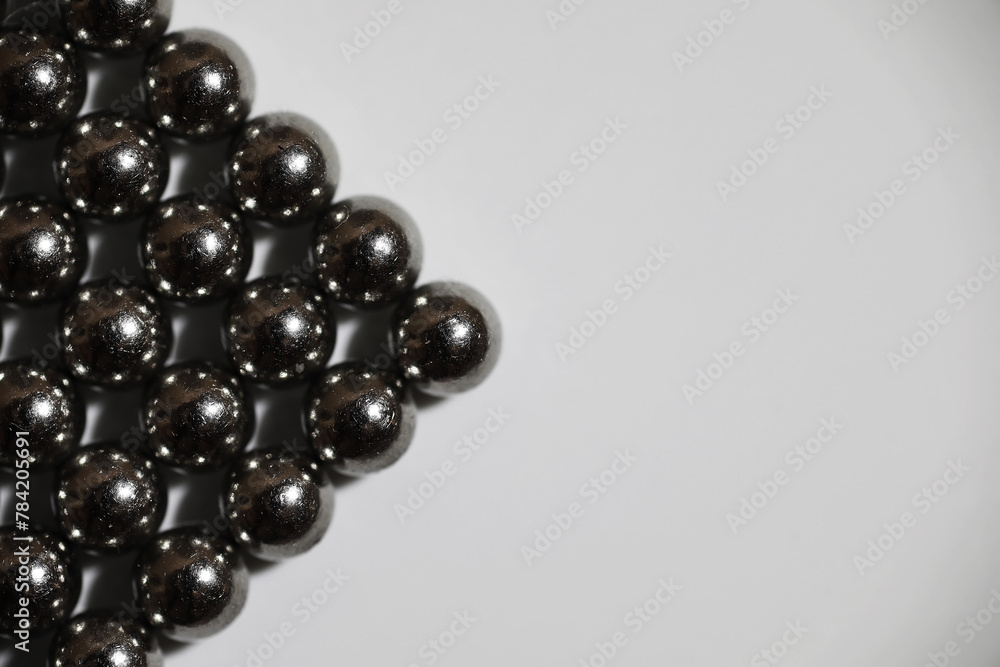 magnetic ball bearing tiling in perfect hexagonal grid. Metal balls ...