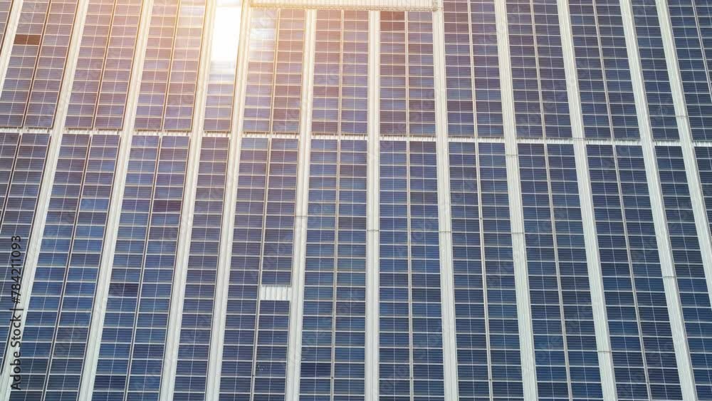 A sea of azure solar panels adorn the rooftop, capturing sunlight with ...