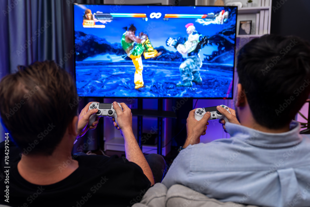 Friend gamers playing video game of battle martial arts fighter on TV ...