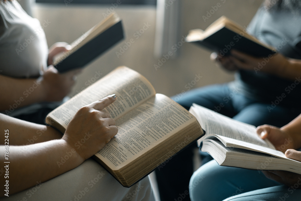 Group of Christian women sat together in chairs, holding their Bibles ...