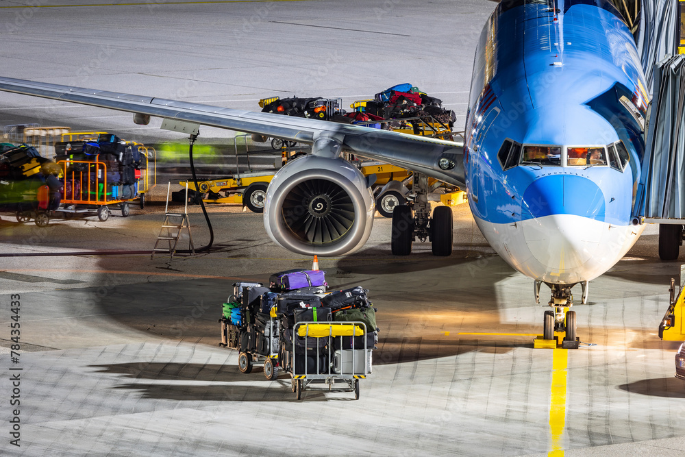 Foto de Baggage ground handling on the airport ramp. Workers loading a ...