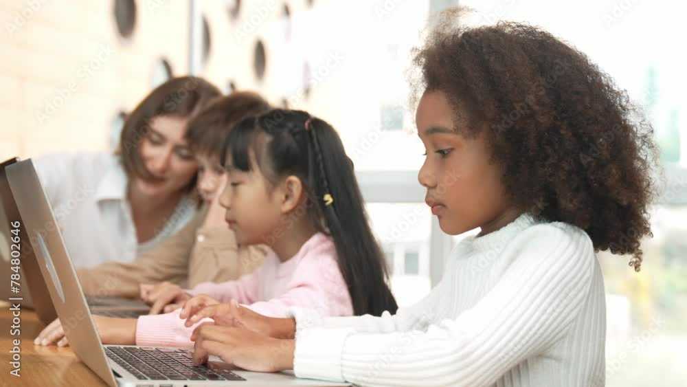 African girl play laptop with diverse friend learning prompt at STEM technology class ...