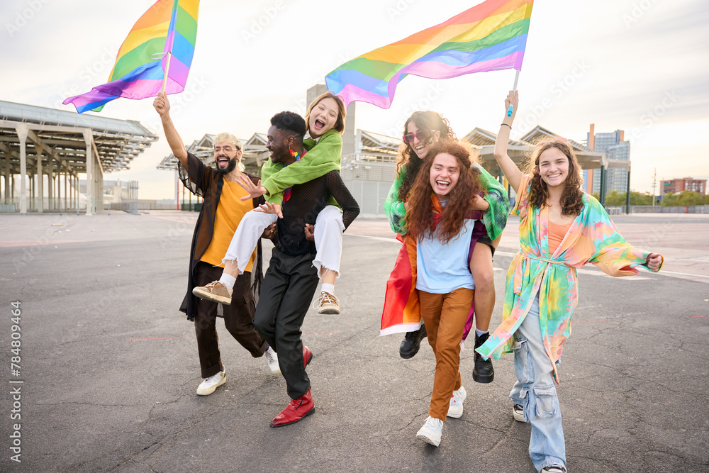 Young LGBT community joyful diverse friends strolling together on day ...