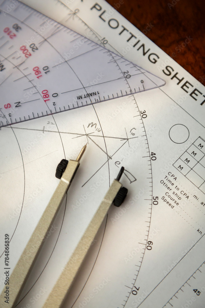 Above image of a navigator's radar plotting chart with a triangler and ...