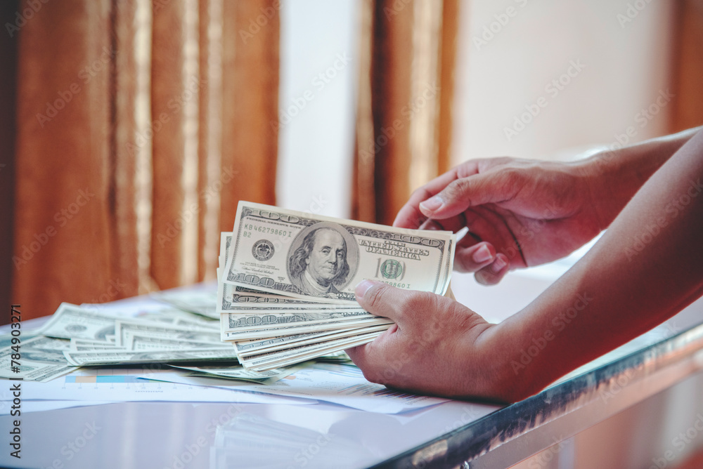 Foto de Hand holding loan money dollar bank note give financial payment ...