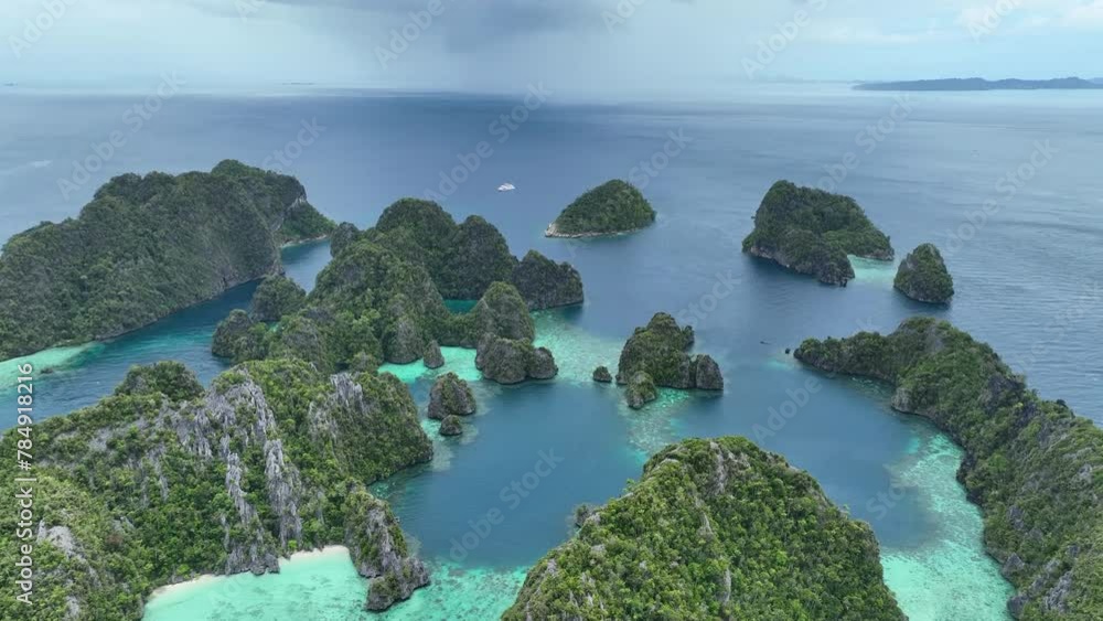 Healthy coral reefs surround rugged islands rising from Raja Ampat's ...