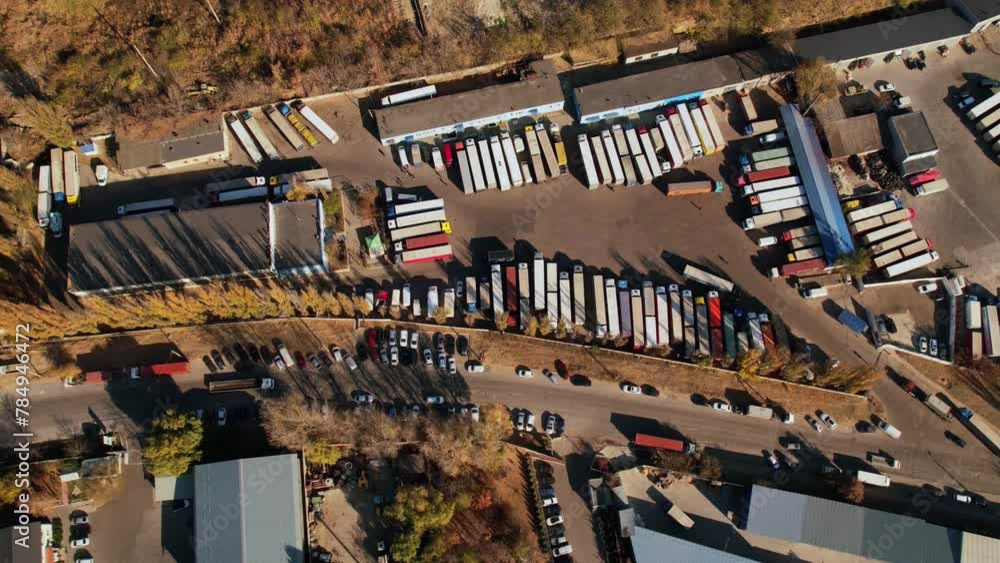 Birdseye view of a bustling parking lot filled with trucks and buses ...