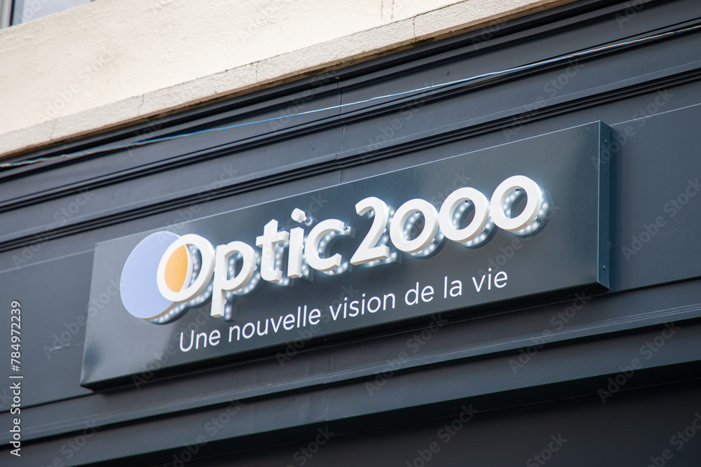 Optic 2000 logo and chain sign text on black background on store street ...