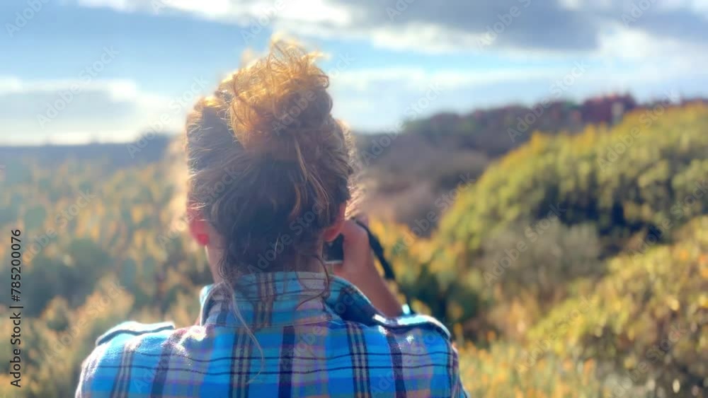 Back view of a woman photographer taking picture outdoor at amazing ...