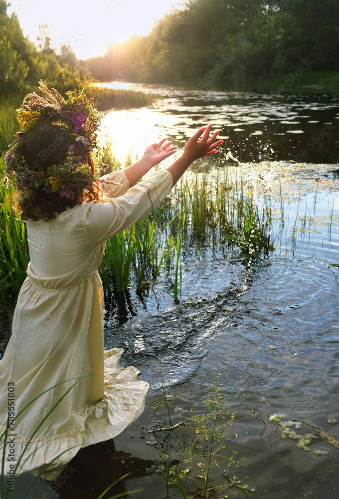 girl in flower wreath stand in river. summer nature background. Floral ...