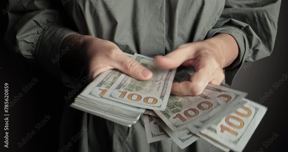 Close-up of hands counting stack of hundred dollar bills. Effective money management. Financial ...