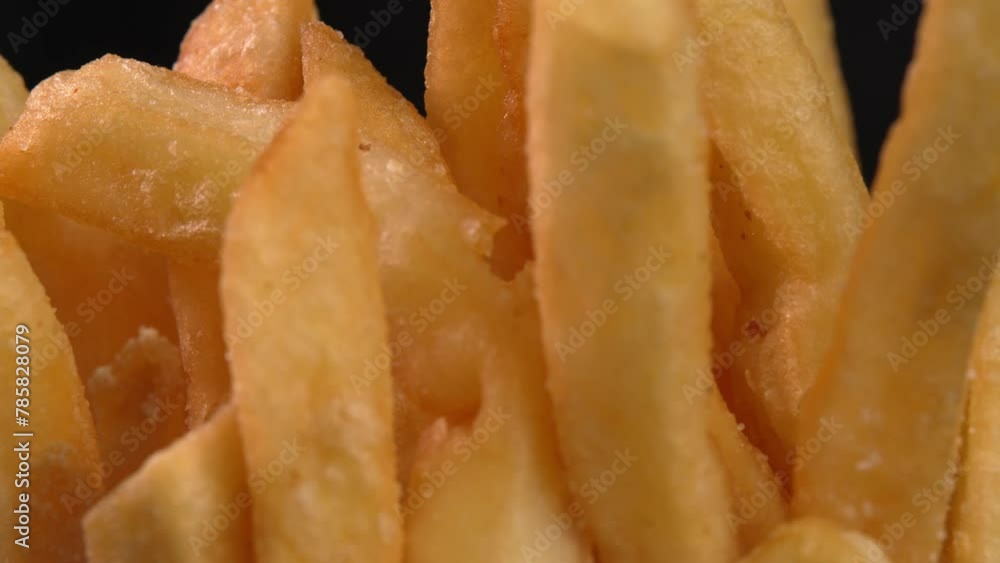 Seasoned fries swirl in paper cup in macro view. Excellent for fast ...