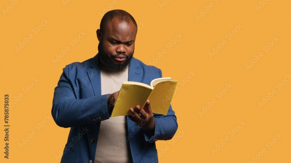 Man struggling to read book with small font, pointing finger to words ...