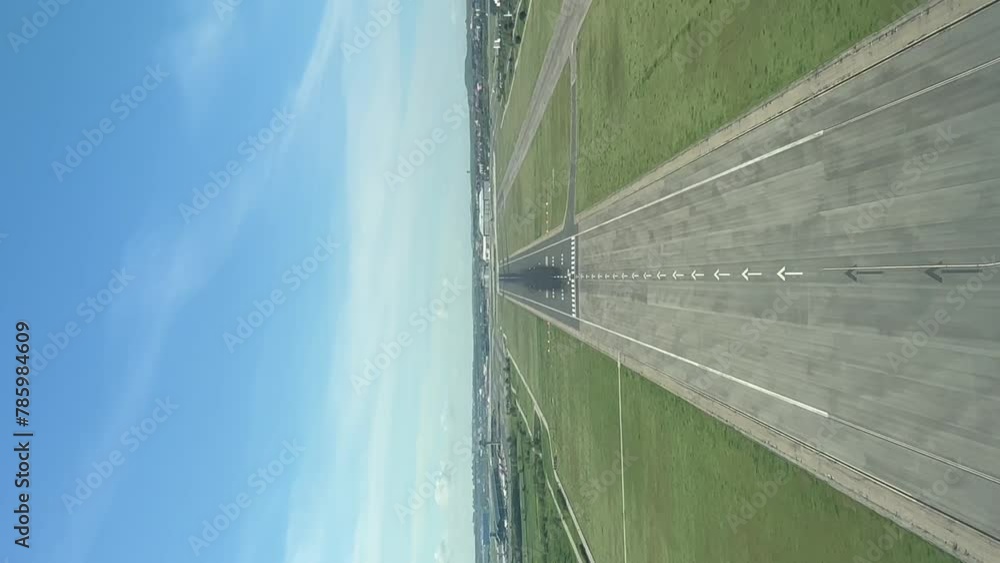 Real time landing on a runway. Vertical shot. Immersive Pilot POV as ...