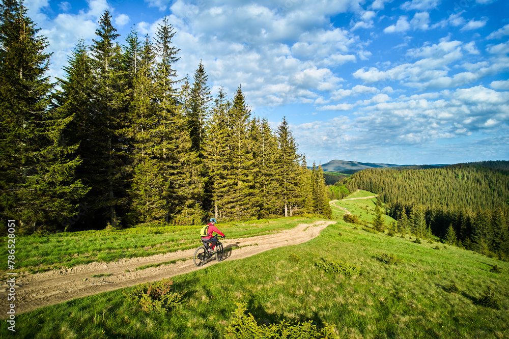 Cyclist man riding electric mountain bike outdoors on sunny day. Male ...