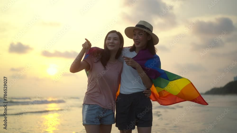 Happy LGBTQ female couple have a romantic moment on the beach. Bisexual ...