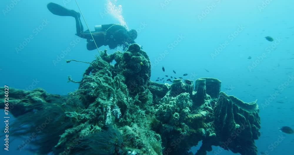 Scuba Diver Exploring Big Ship Wreck. The ship was Japanese and sunk ...