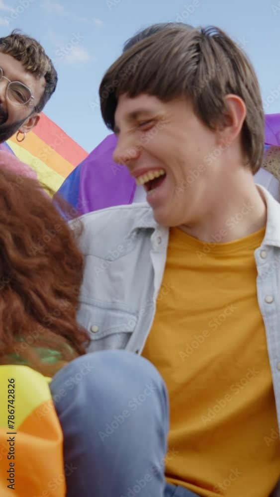 Vertical. LGBT diverse group friends laughing happy sitting together ...
